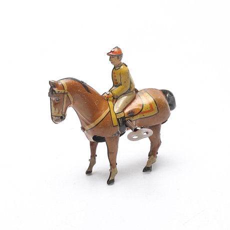 A lithographed sheet toy, jockey on a galloping horse, Germany, first ...