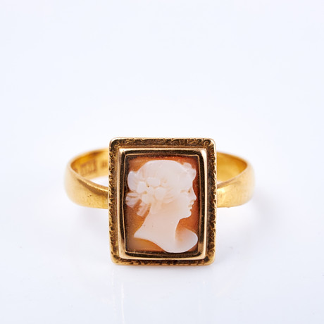 A ring, 23 k gold, inset cut seashell camé depicting a woman's profile ...