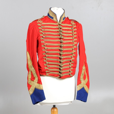A FINELY TAILORED SCARLET, BLUE AND GILT HUSSARS JACKET AND CAP ...