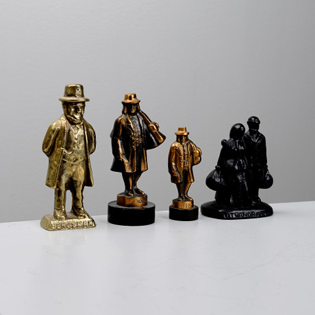 A set of four figures, ore, brass and cast iron, 20th century. Silver ...