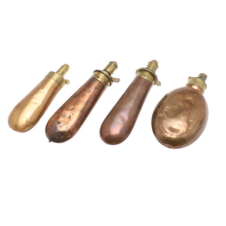 A COLLECTION OF FOUR VICTORIAN AND LATER COPPER BODIED POWDER FLASKS ...