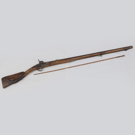 A 19th century wooden battle-lock rifle with charging stake. Weapons ...
