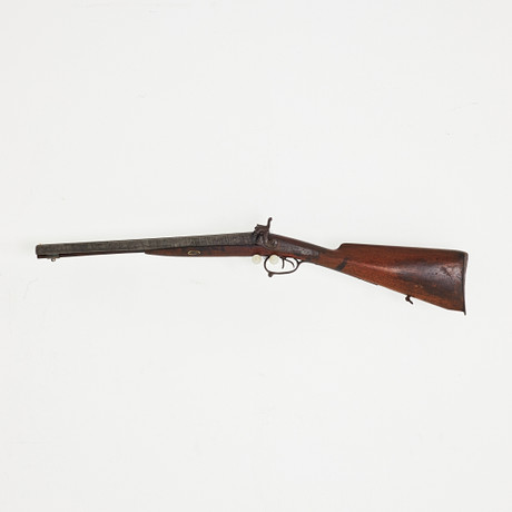 A double-barreled breech-loading rifle, unmasked barrel, blackened log ...
