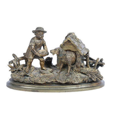 A LATE 19TH CENTURY BRONZE INKWELL, CAST AS A BOY FEEDING A DOG IN A ...