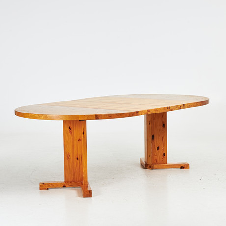 A dining table, circa 1970's, pine, round, two inserts with sash ...
