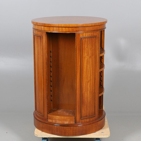 MARTIN J DODGE. A FIGURED SAPELE CYLINDRICAL ROTATING BOOKCASE WITH ...