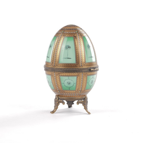 A porcelain egg, with brass frame, Fabergé style, Limoges, France, last ...