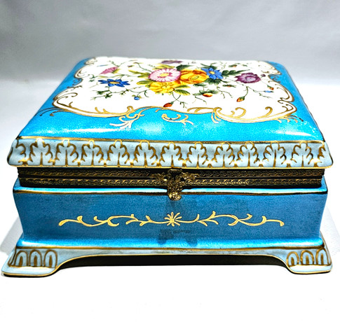 Porcelain collection box with flower motif on a blue background ...