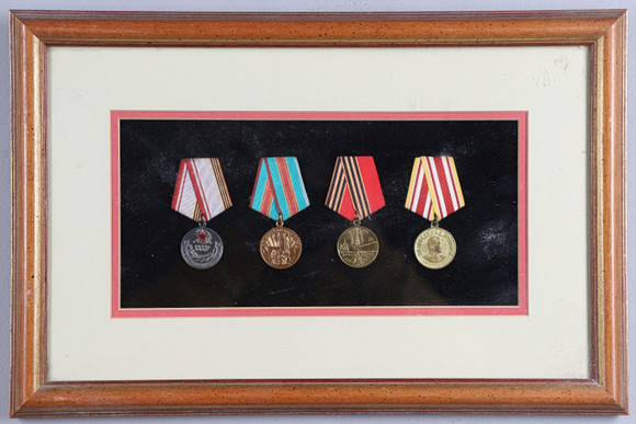 A FRAMED COLLECTION OF FOUR SECOND WORLD WAR RUSSIAN MILITARY MEDALS ...