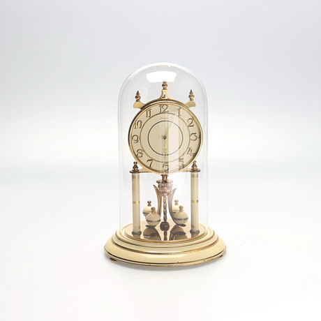 TABLE CLOCK. A brass Kundo with glass cup, Germany, 20th century ...