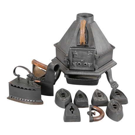 Small cast iron iron stove with div. irons, late 19th century (11 ...